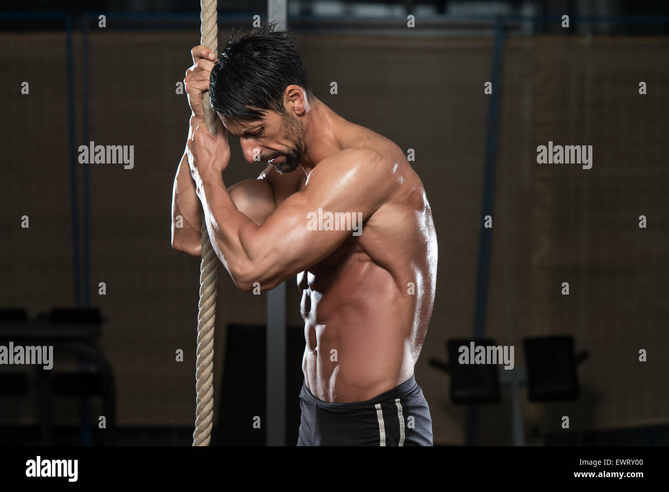 Man Resting After Fitness Rope Climb Exercise In Fitness Gym Workout ...