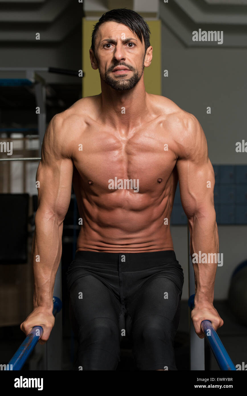 Fit Athlete Working Out Exercise On Parallel Bars Stock Photo - Alamy
