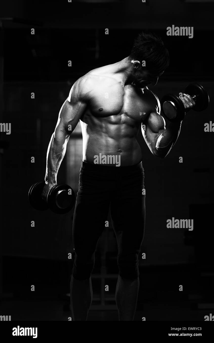 Fit Athlete Working Out Biceps - Dumbbell Concentration Curls Stock ...