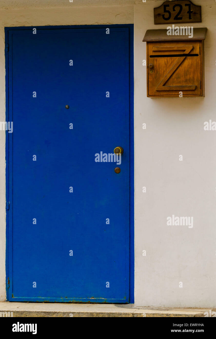Blue entrance door on cement colored building Stock Photo - Alamy