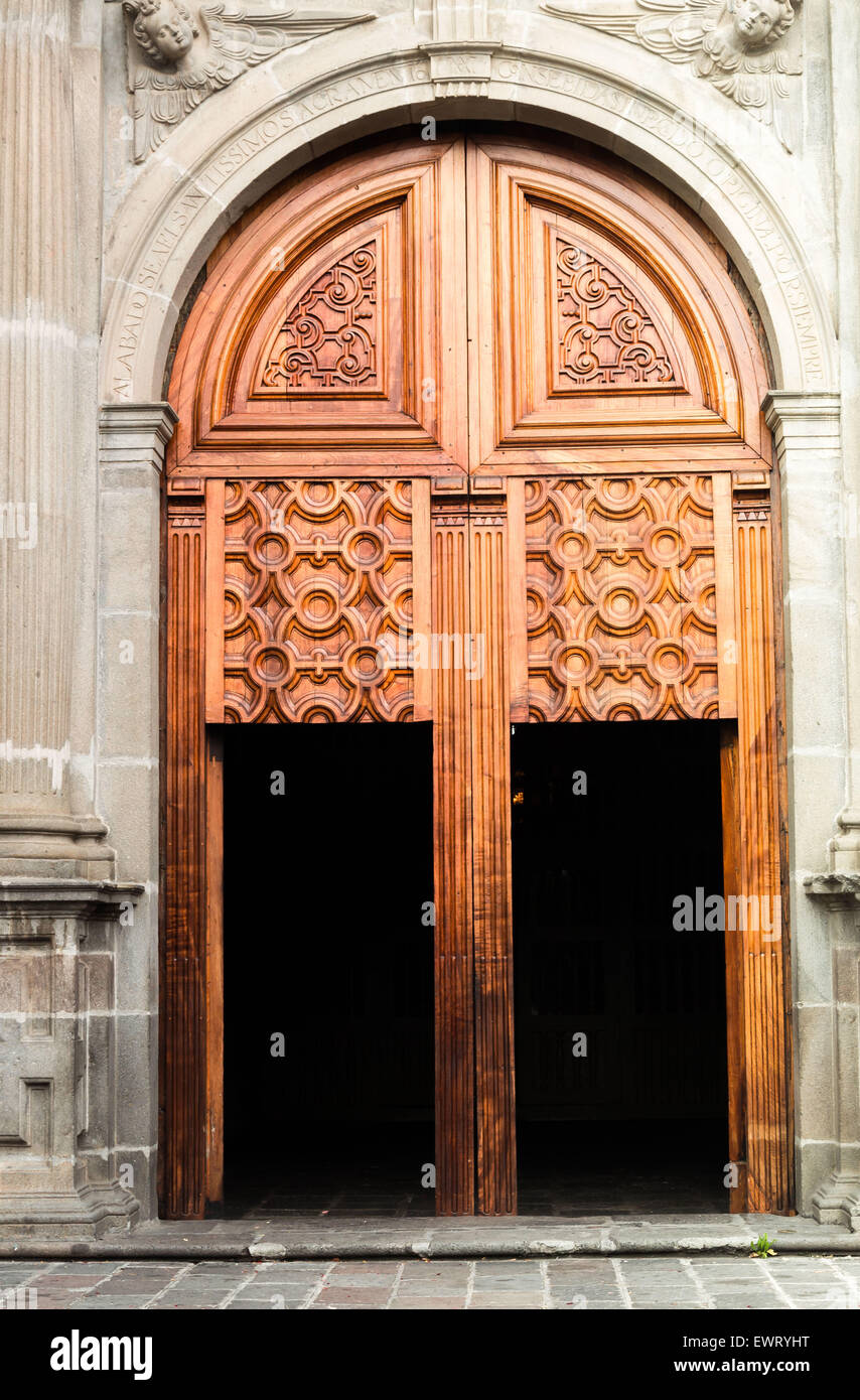 Giant wooden gate with smaller doors integrated on massive concrete ...
