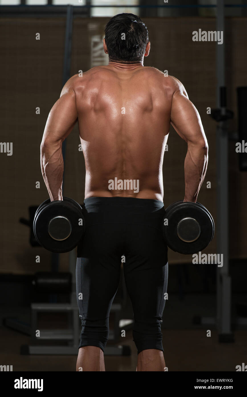 Fit Athlete Working Out Trapezius - Dumbbell Concentration Curls Stock ...