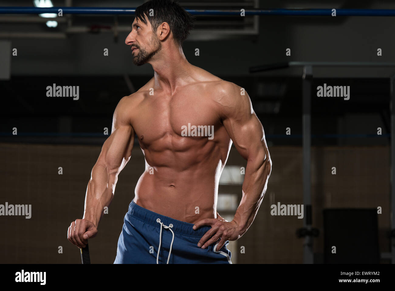 Portrait Of A Physically Fit Man Working Out With Hammer And Tractor ...