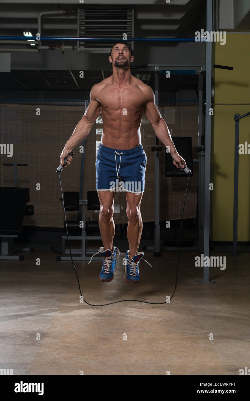 Young Man In Gym Is Jumping Rope Stock Photo - Alamy
