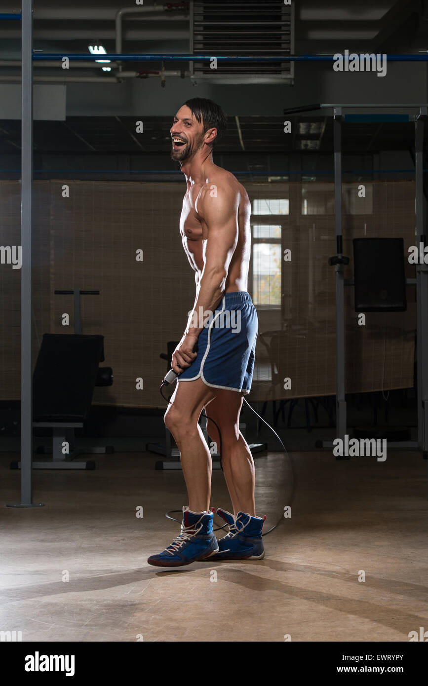 Young Man In Gym Is Jumping Rope Stock Photo - Alamy