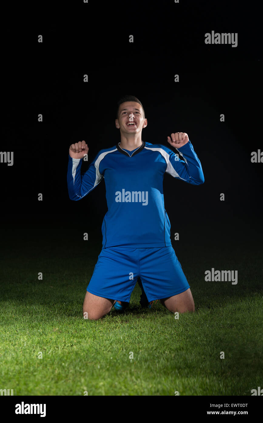 Man Soccer Player Celebrating Victory In Blue Uniform On Black ...