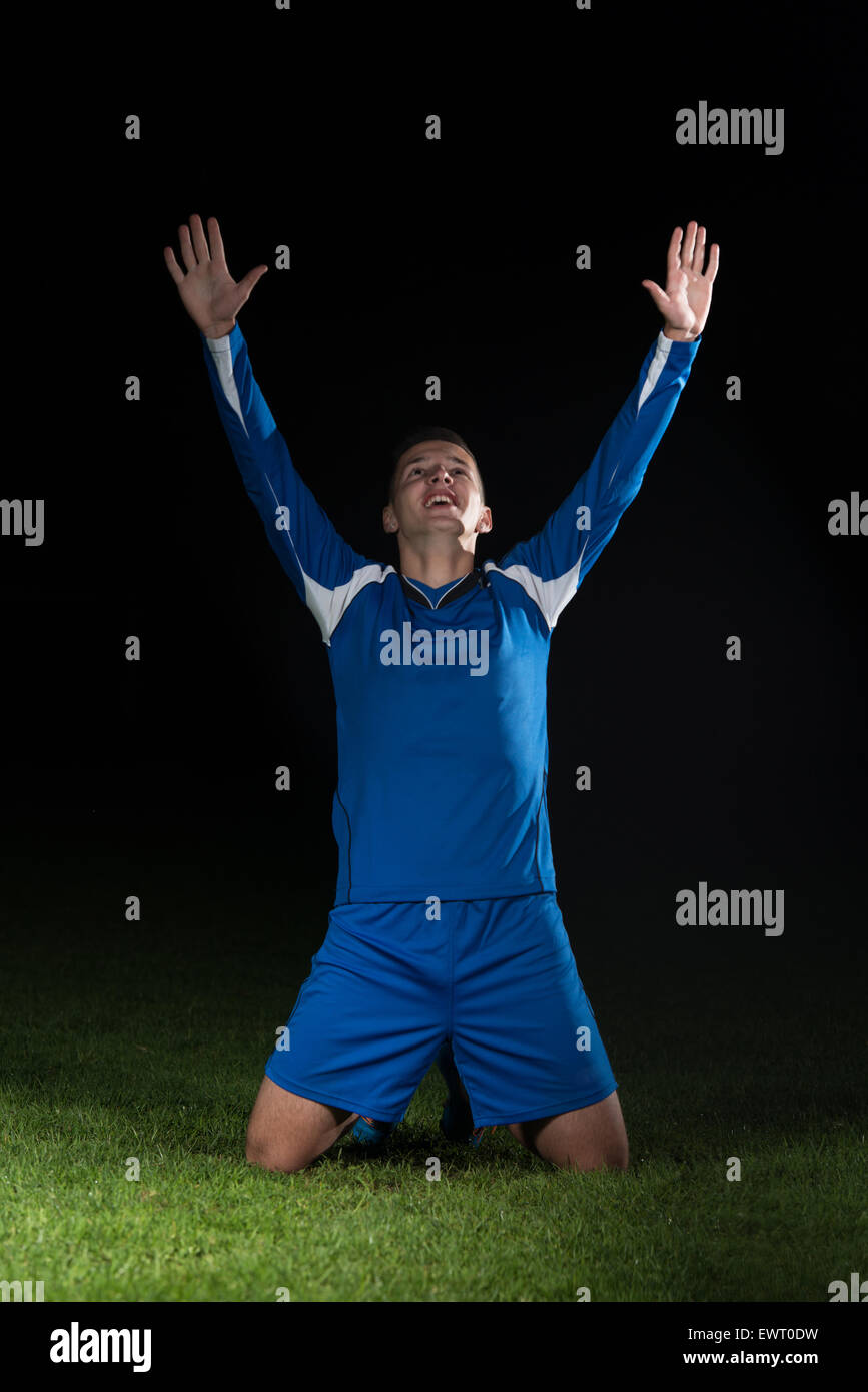 Man Soccer Player Celebrating Victory In Blue Uniform On Black ...