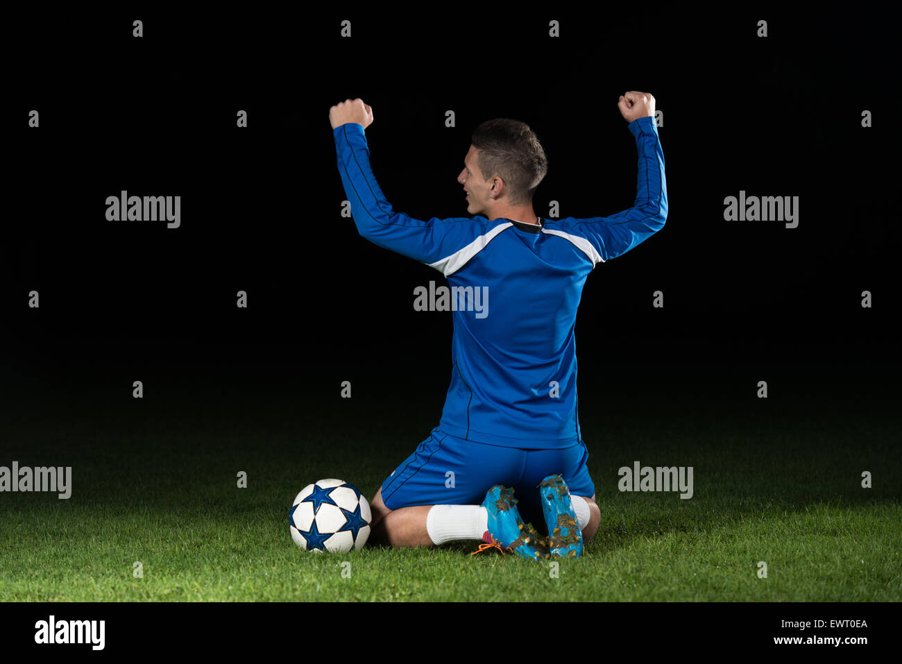 Man Soccer Player Celebrating Victory In Blue Uniform On Black ...