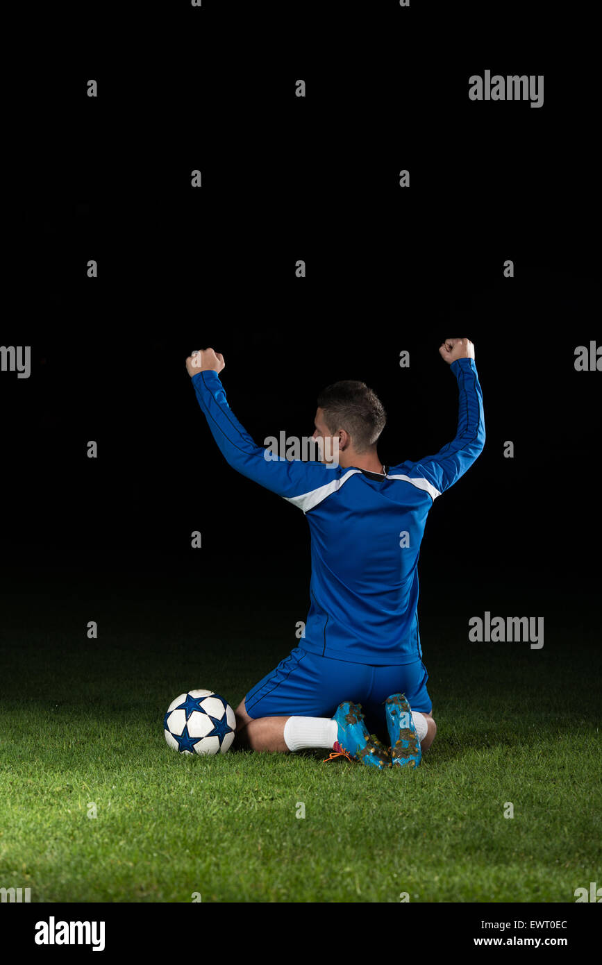 Man Soccer Player Celebrating Victory In Blue Uniform On Black ...