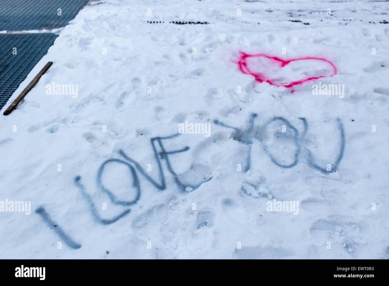 I love you, written in capital letters on frozen white snow with drawn ...