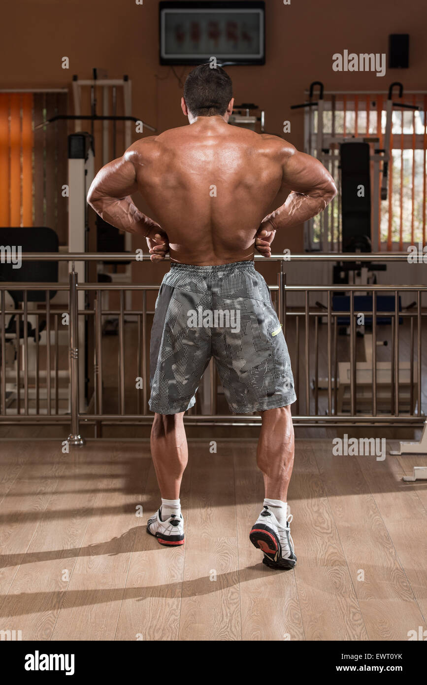 Bodybuilder Standing In The Gym And Flexing Muscles Stock Photo - Alamy