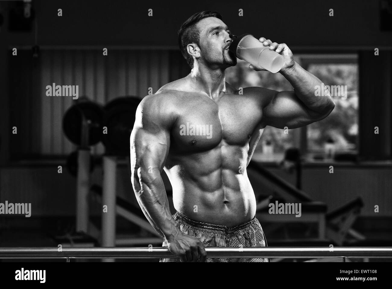 Muscular Man Drinking A Water Bottle Stock Photo - Alamy