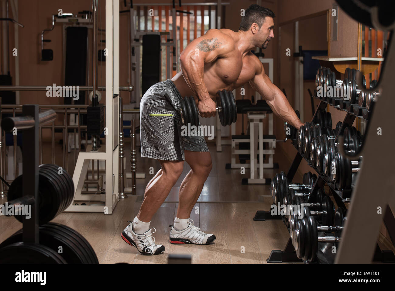 Mexican Bodybuilder Doing Heavy Weight Exercise For Back With Dumbbells ...