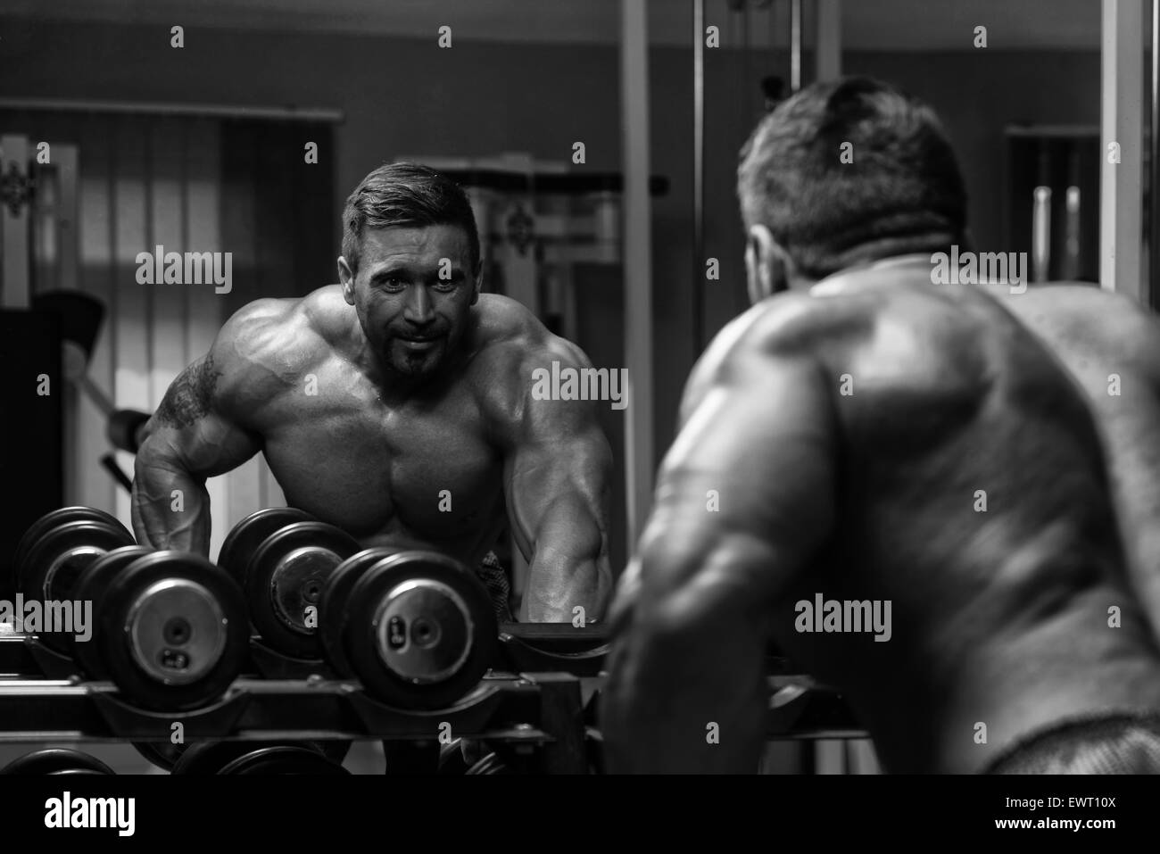Mexican Bodybuilder Doing Heavy Weight Exercise For Back With Dumbbells ...