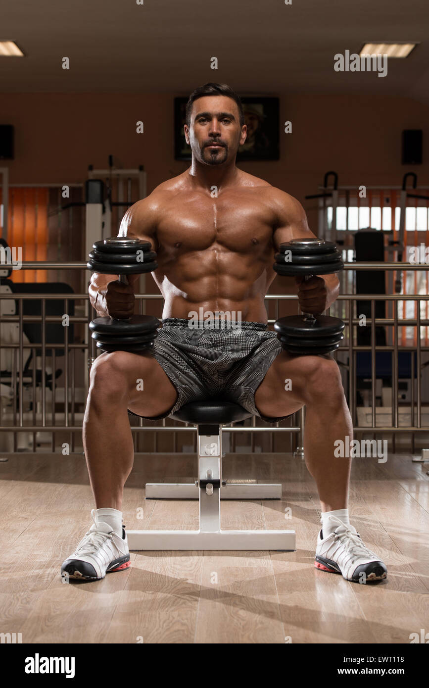 Hispanic Bodybuilder Working Out Shoulders - Dumbbell Concentration ...