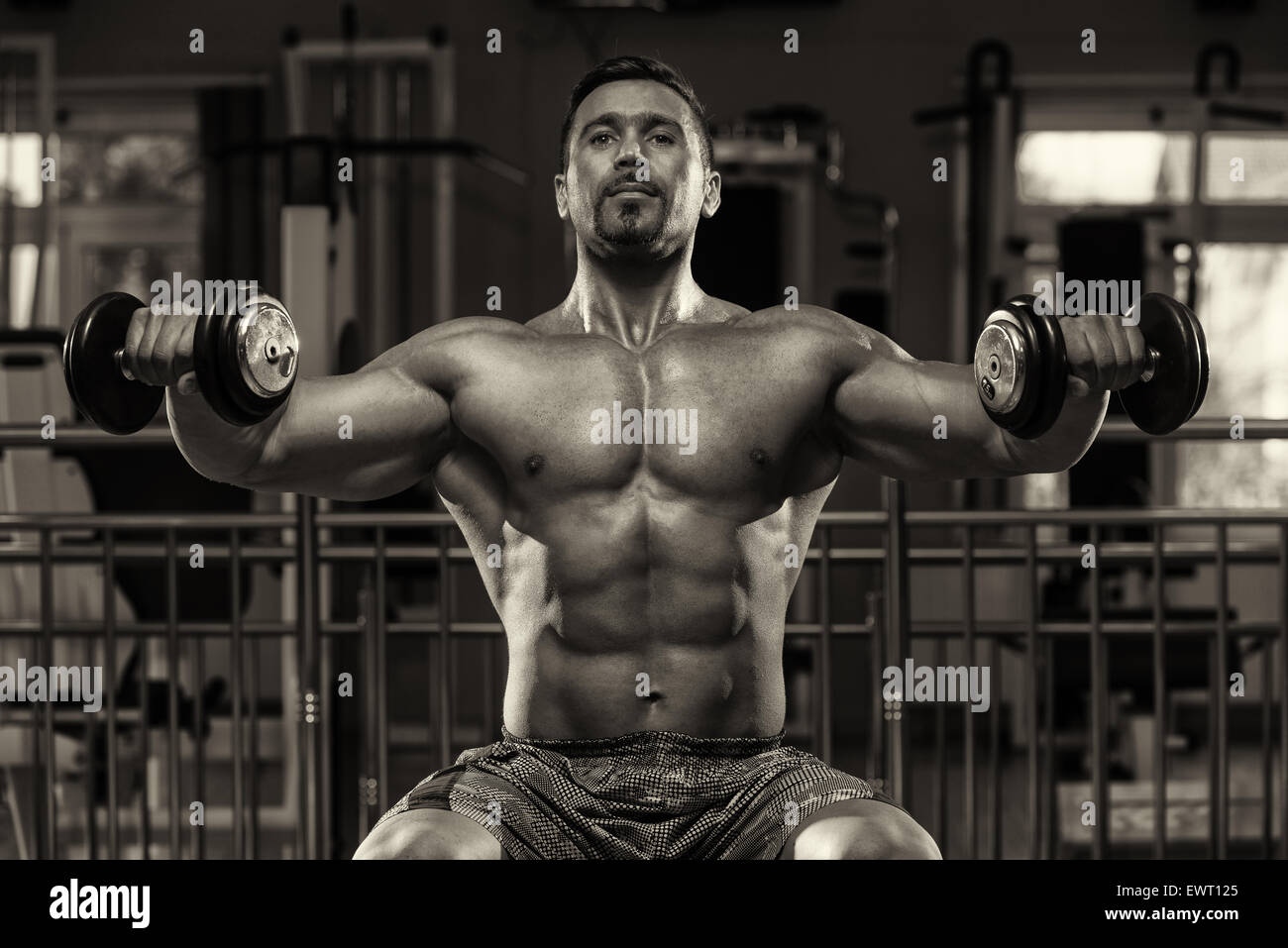 Hispanic Bodybuilder Working Out Shoulders - Dumbbell Concentration ...