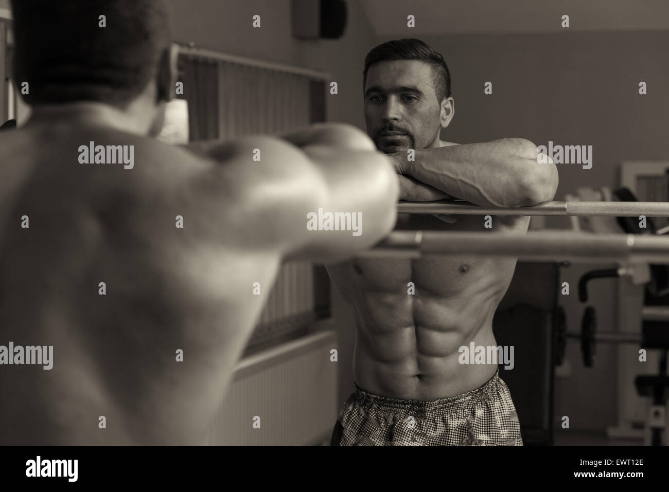 Muscular Man Flexing Abdominal Muscles Abs In A Health Club Stock Photo ...