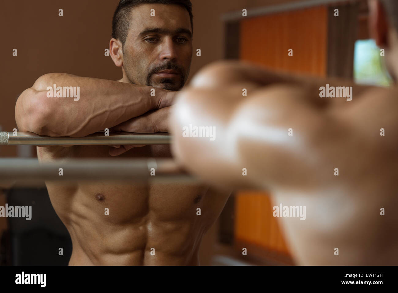 Muscular Man Flexing Abdominal Muscles Abs In A Health Club Stock Photo ...