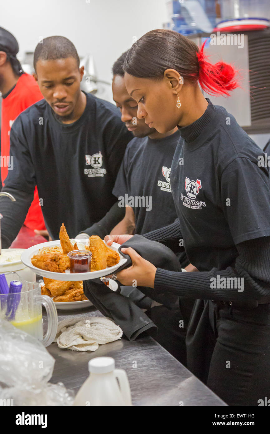 Detroit, Michigan - Kitchen workers at Kuzzo's Chicken & Waffles Stock ...