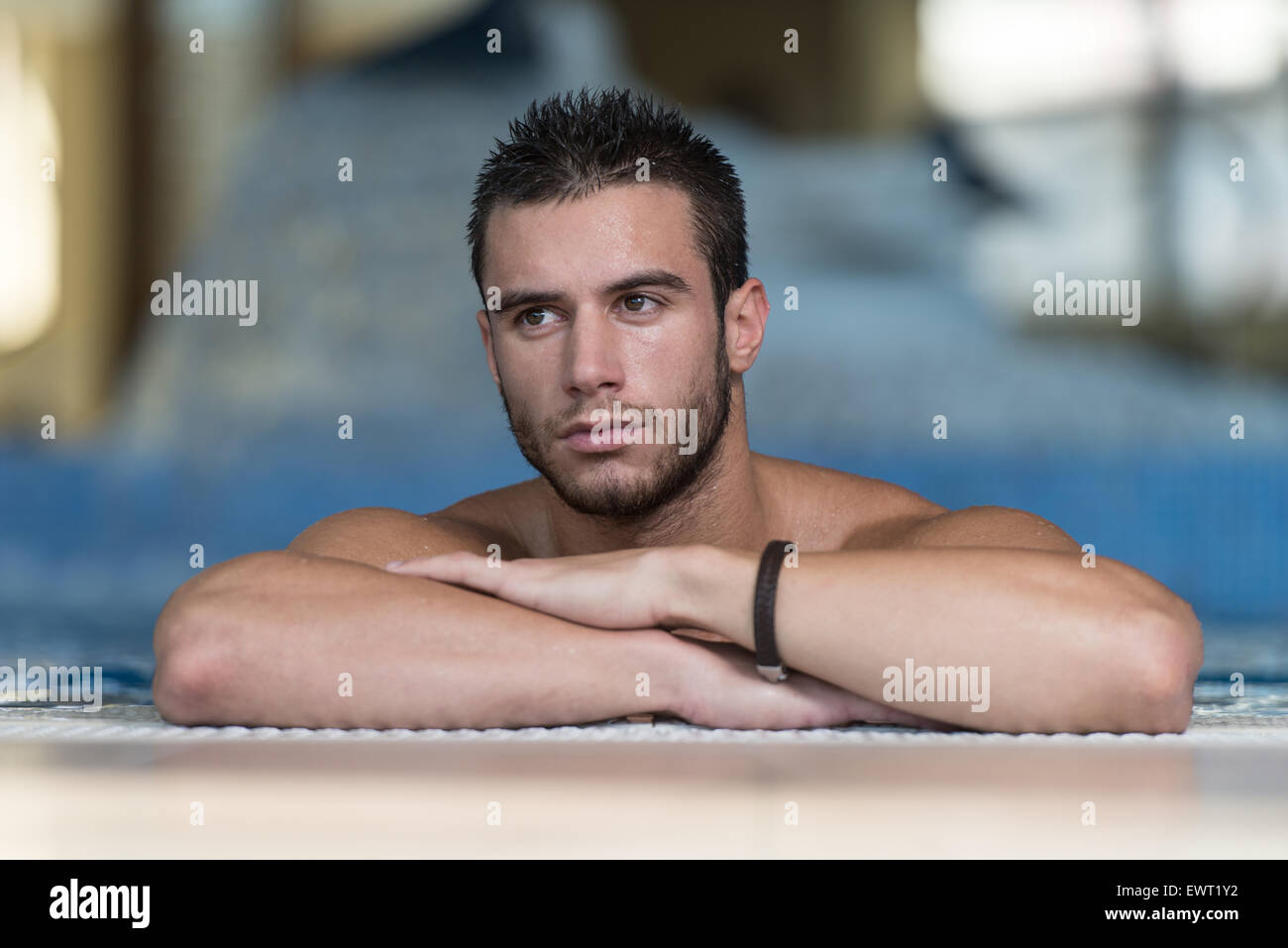 Happy Attractive Man Resting Relaxed On Edge Of Swimming Pool Stock ...
