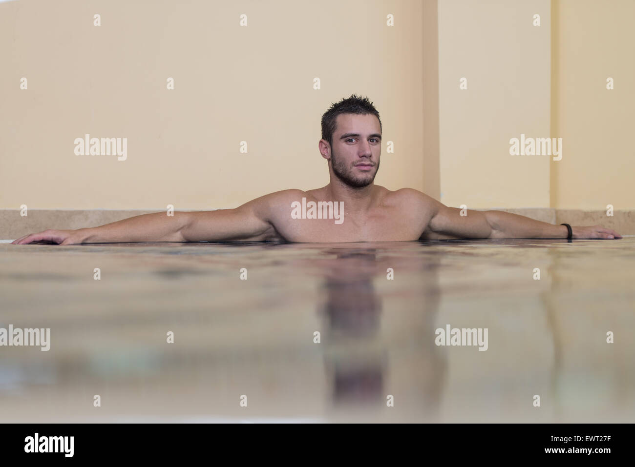 Happy Attractive Man Resting Relaxed On Edge Of Swimming Pool Stock ...