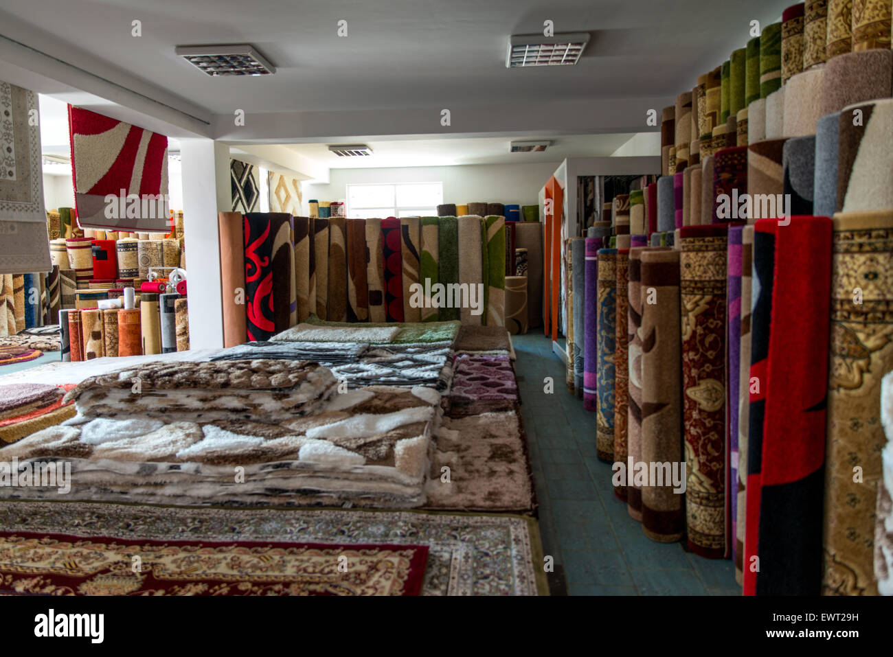 Colorful Collection Of Carpets And Rugs Folded And Displayed. Textured ...