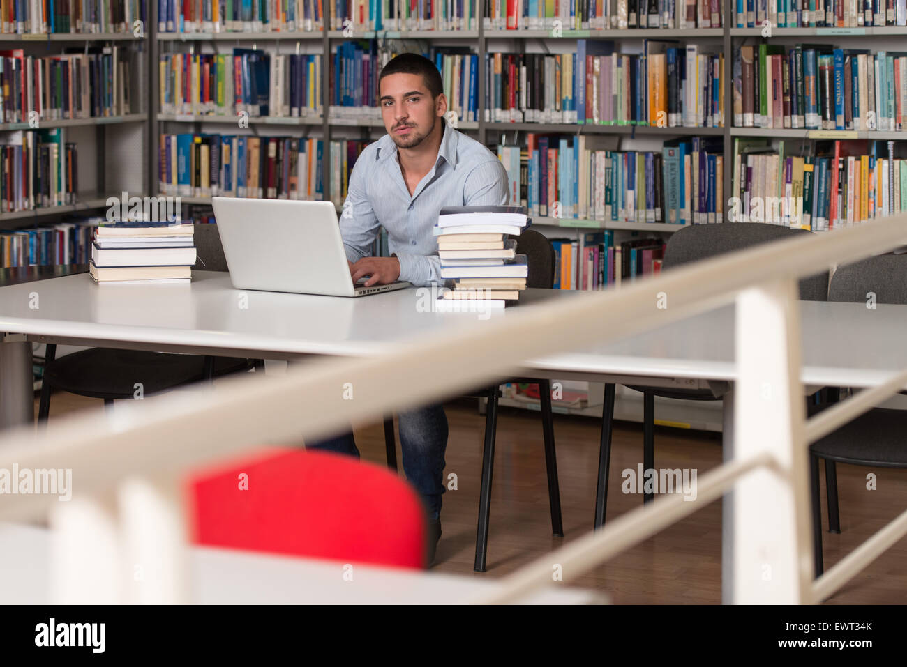 In The Library - Handsome Male Student With Laptop And Books Working In ...