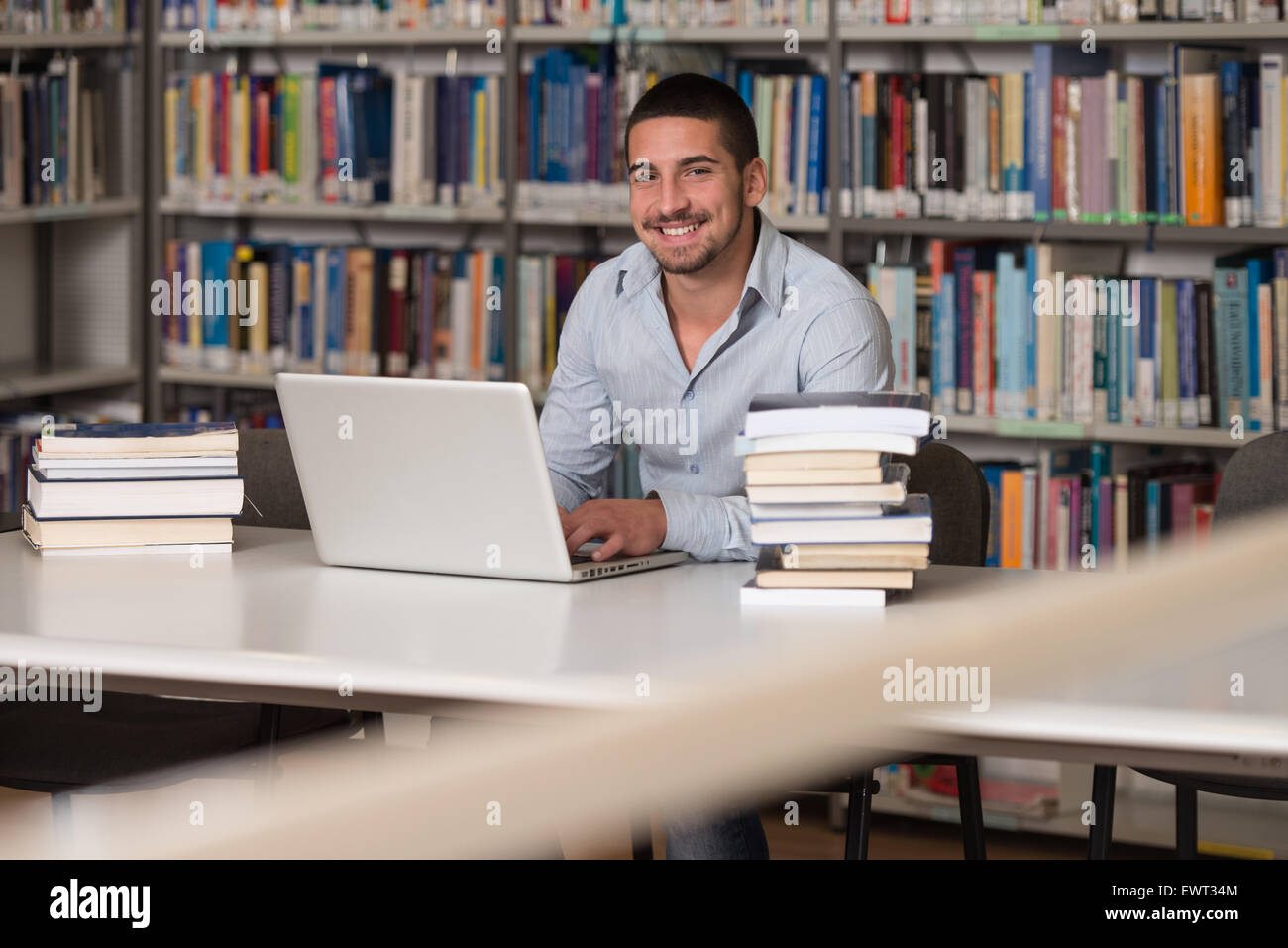 In The Library - Handsome Male Student With Laptop And Books Working In ...