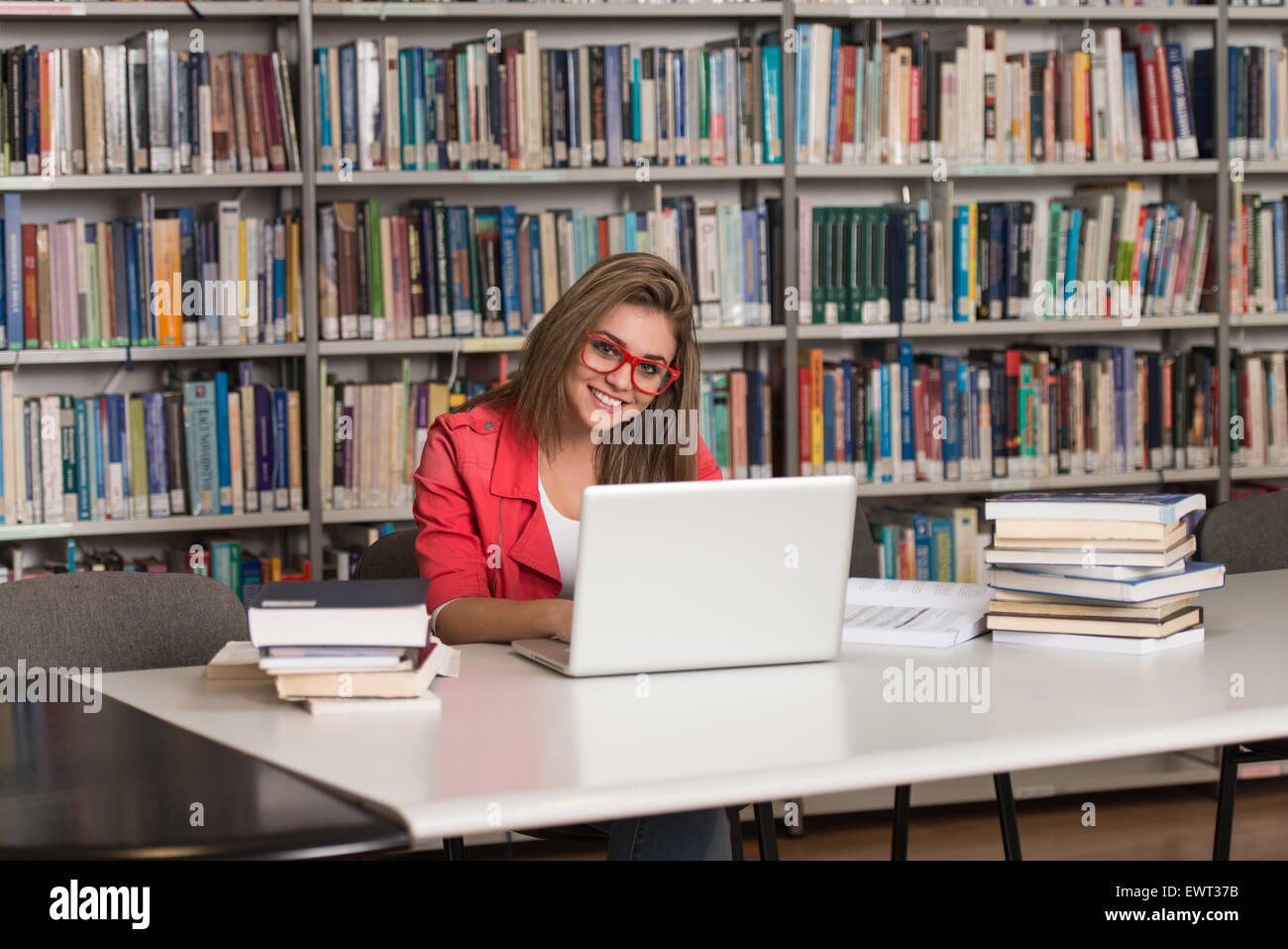 In The Library - Pretty Female Student With Laptop And Books Working In ...