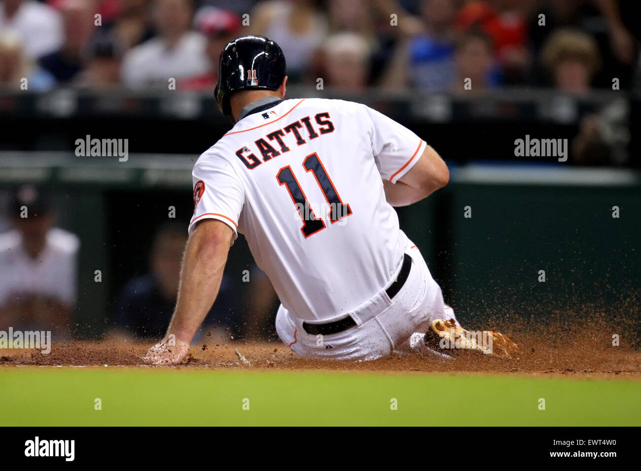 Houston, TX, USA. 30th June, 2015. Houston Astros designated hitter Evan Gattis #11 slides into ...