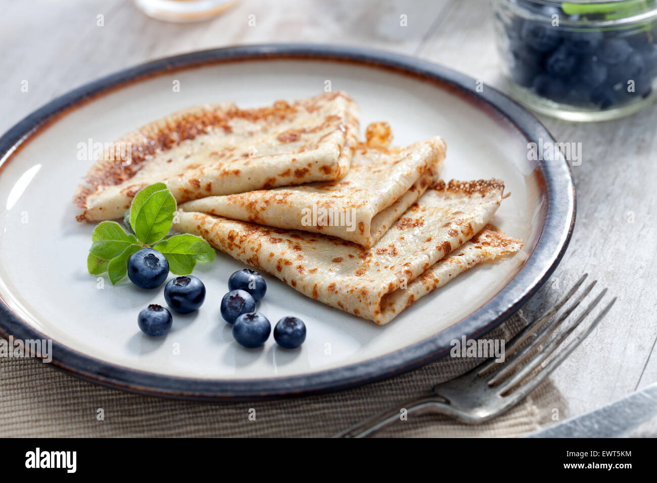 close up view of nice yummy crepes with blueberry on table Stock Photo ...