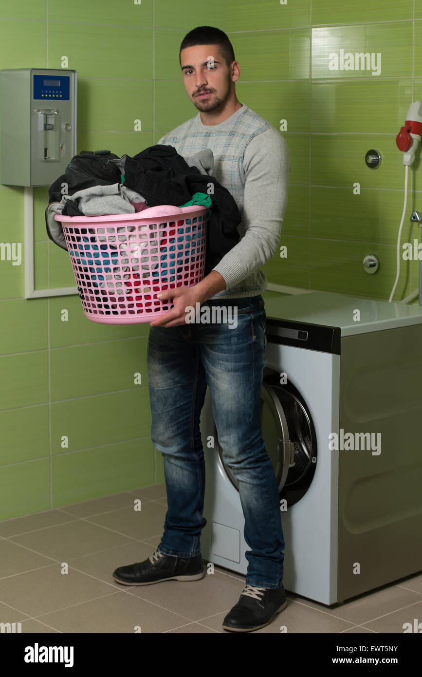 Handsome Young Man In The Laundry Room Stock Photo - Alamy