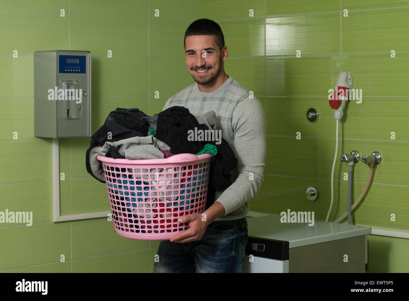 Handsome Young Man In The Laundry Room Stock Photo - Alamy
