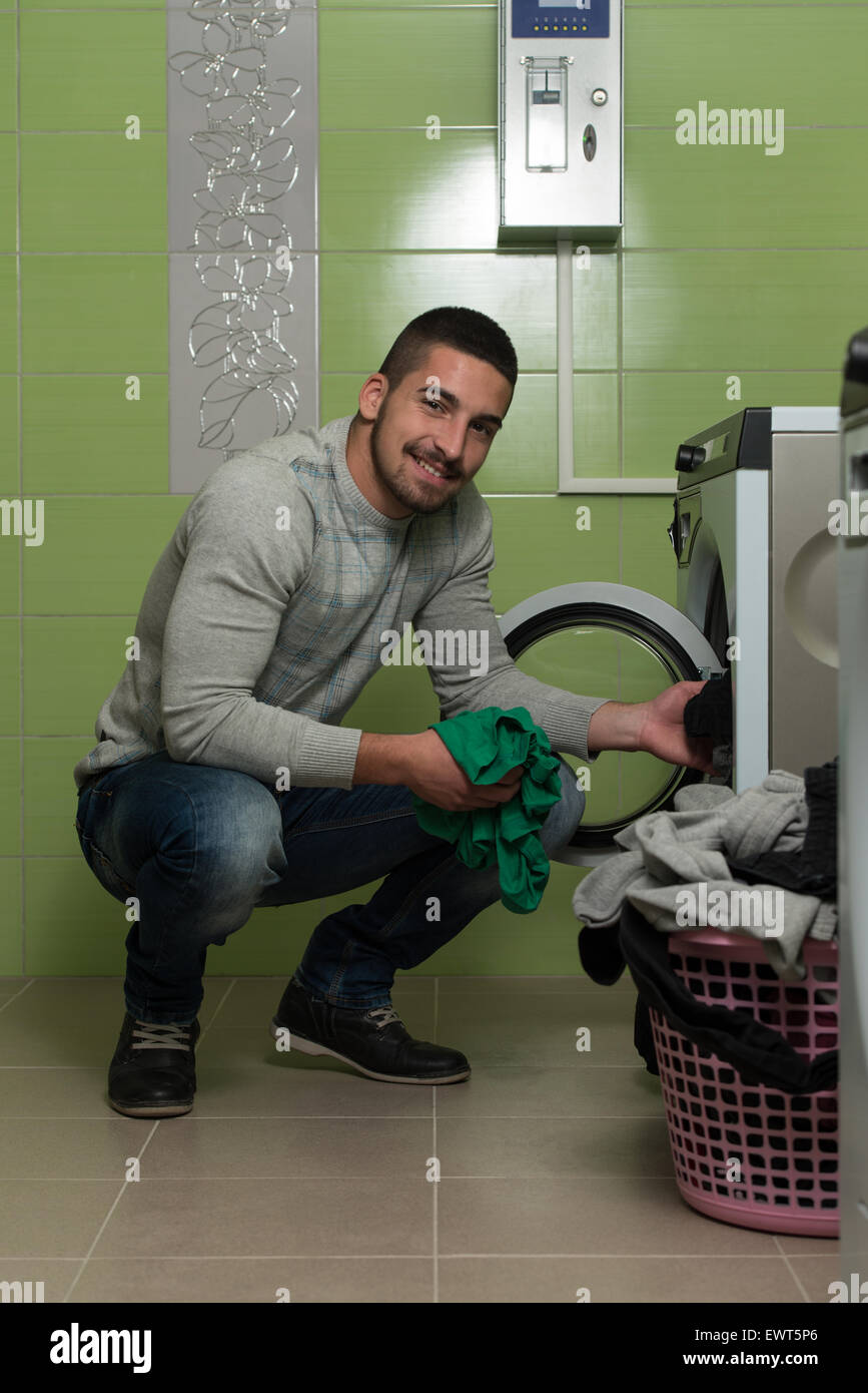 Handsome Young Man In The Laundry Room Stock Photo - Alamy