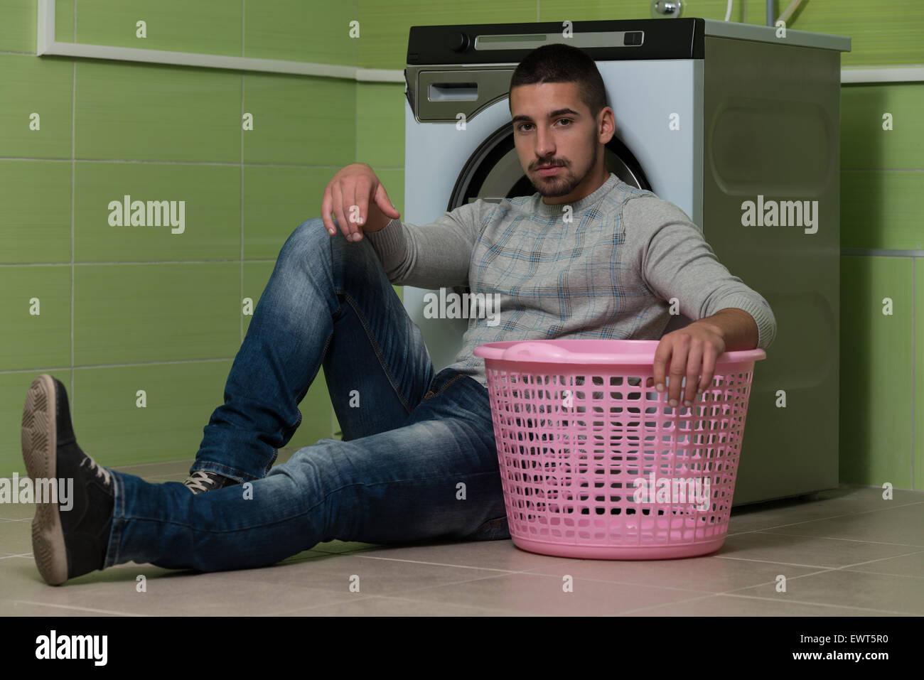 Handsome Young Man In The Laundry Room Stock Photo - Alamy