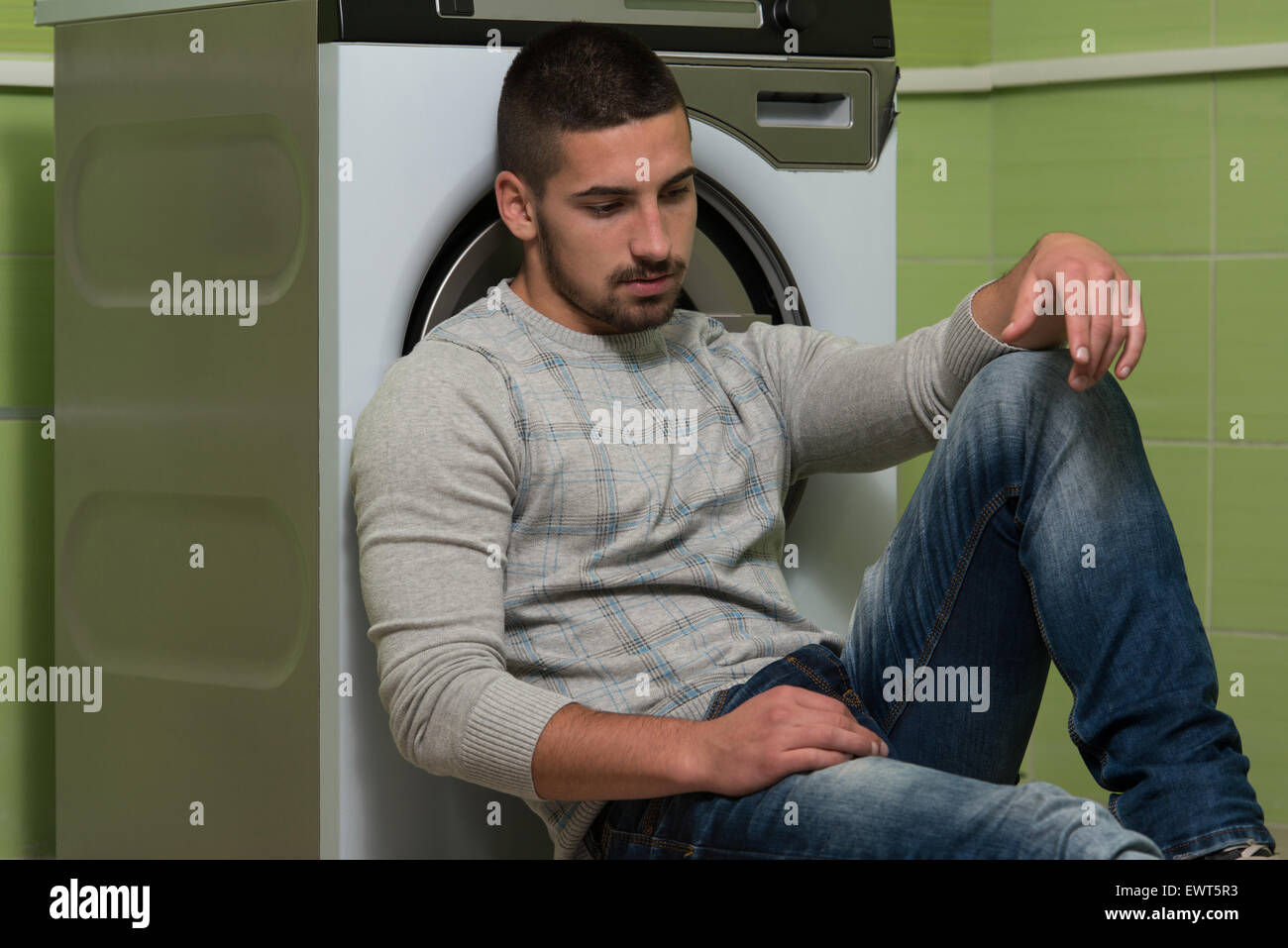 Handsome Young Man In The Laundry Room Stock Photo - Alamy