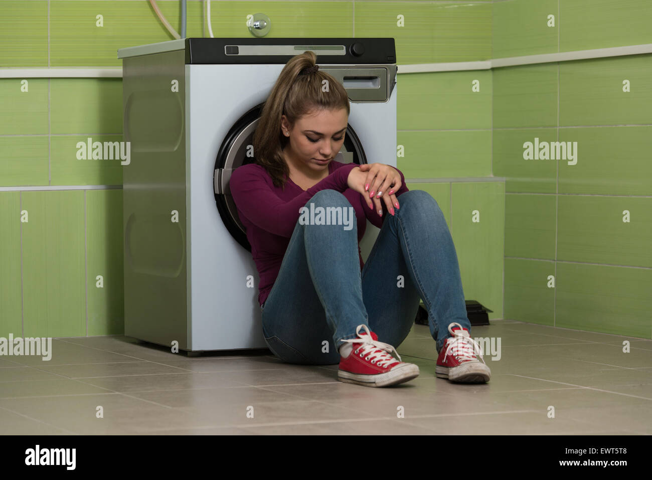 Pretty Smiling Girl In The Laundry Room Stock Photo - Alamy