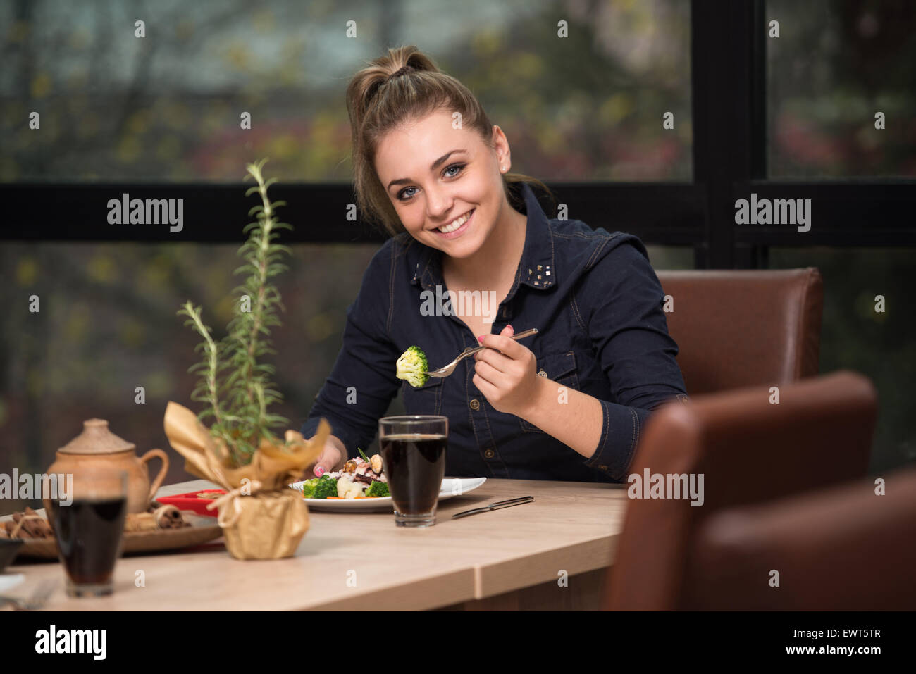 Beautiful Girl Eating At A Restaurant And Looking Happy Stock Photo - Alamy