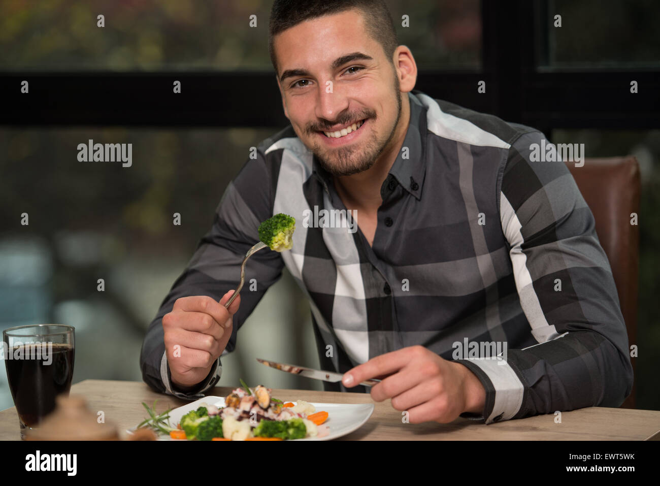 Handsome man eating hi-res stock photography and images - Alamy