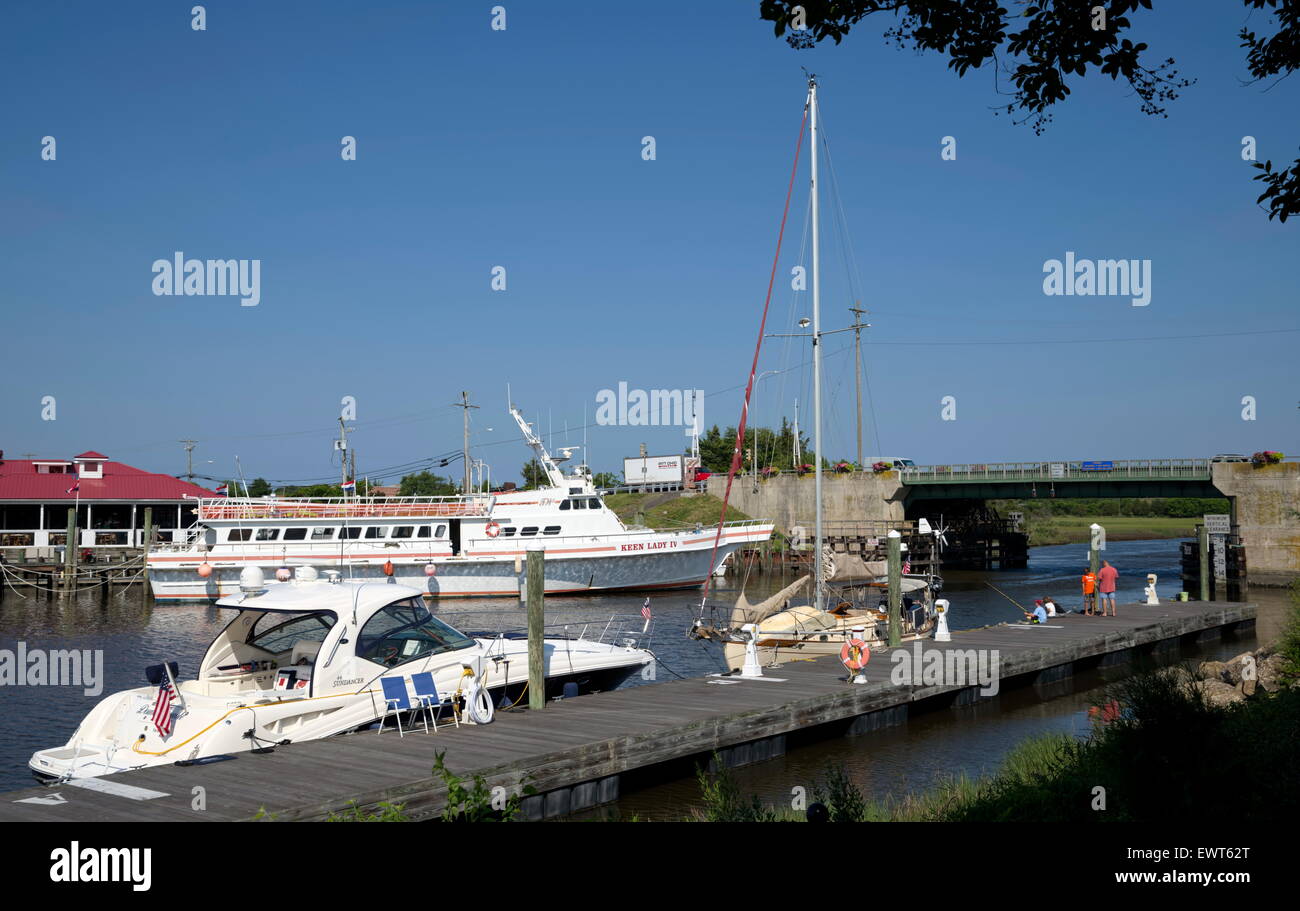 Power boats and a sailboat dock near a drawbridge in Lewes, Delaware ...