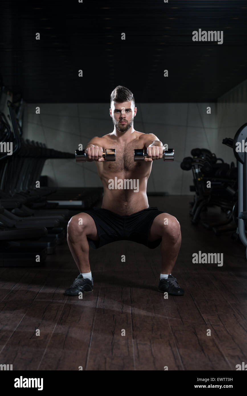 Young Man Performing Dumbbell Squats - One Of The Best Bodybuilding ...