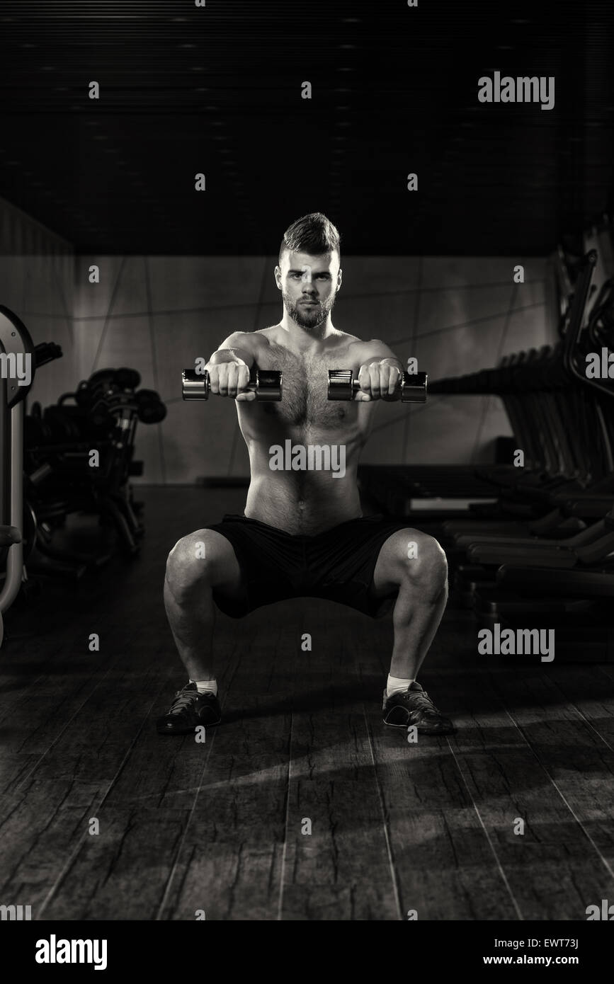 Young Man Performing Dumbbell Squats - One Of The Best Bodybuilding ...