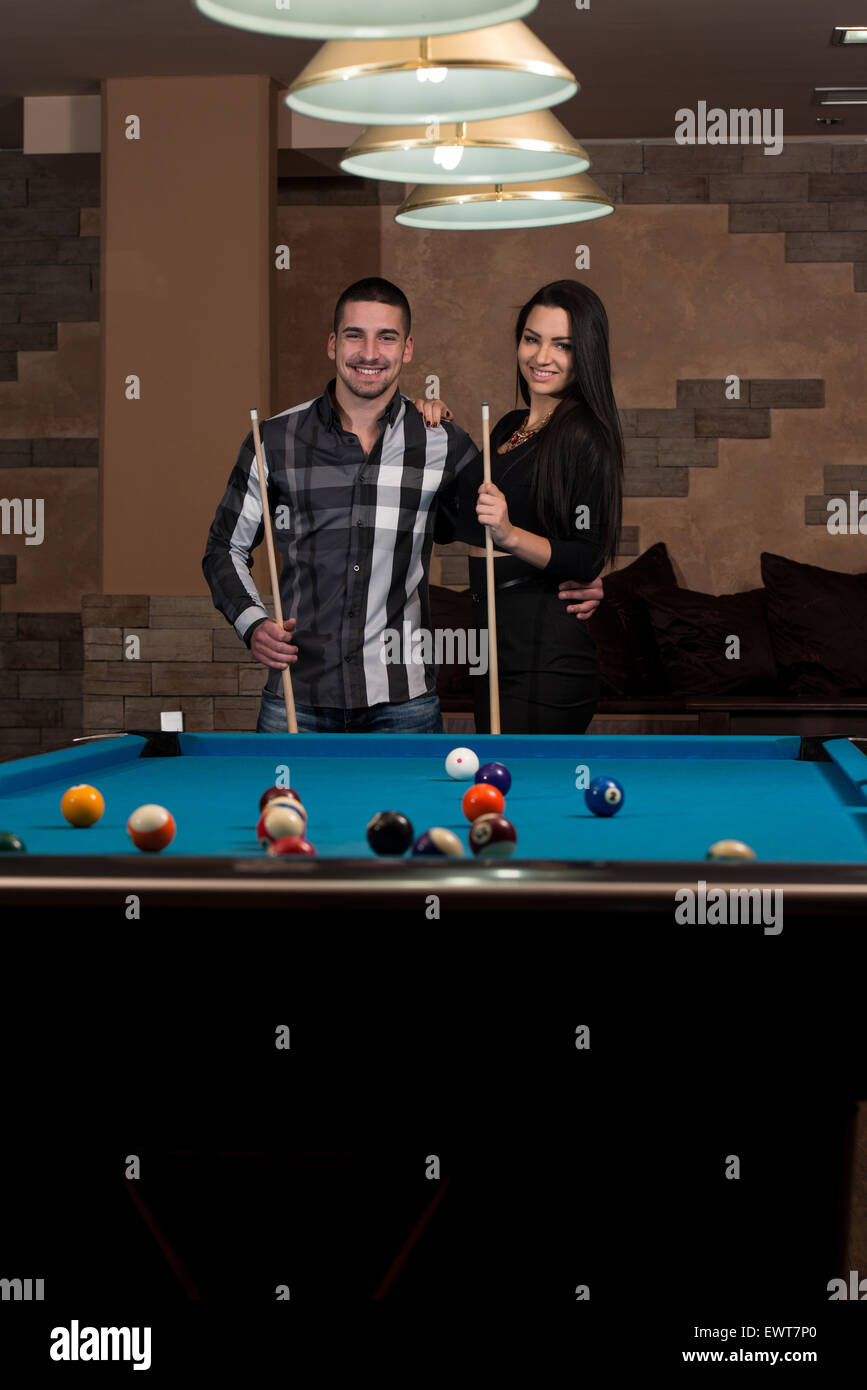 Portrait Of A Young Couple Playing Billiards Stock Photo - Alamy