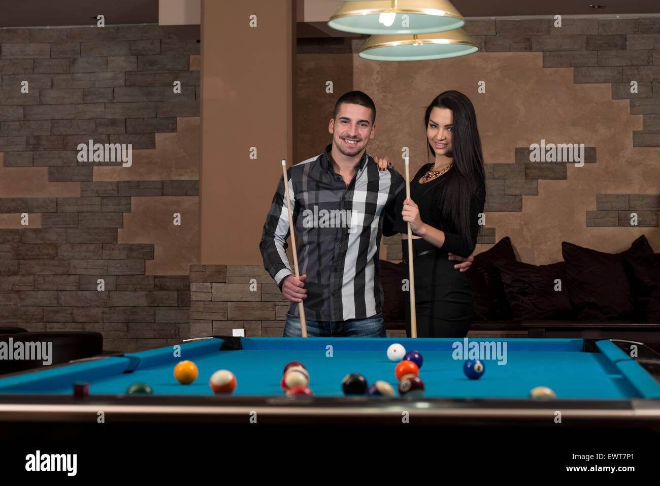 Portrait Of A Young Couple Playing Billiards Stock Photo - Alamy