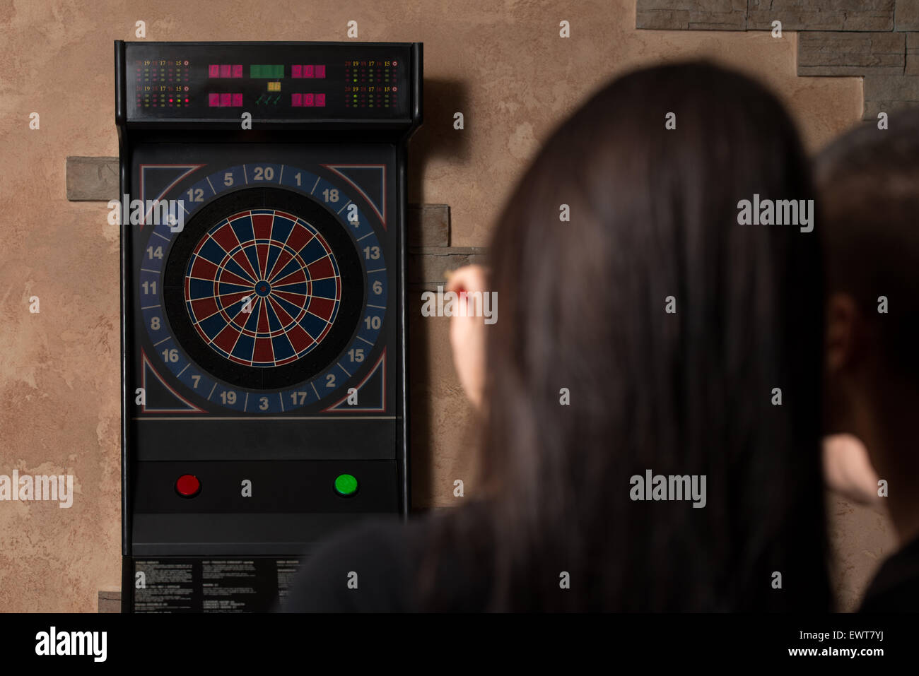 Young Couple Playing A Game Shooting Darts Stock Photo - Alamy