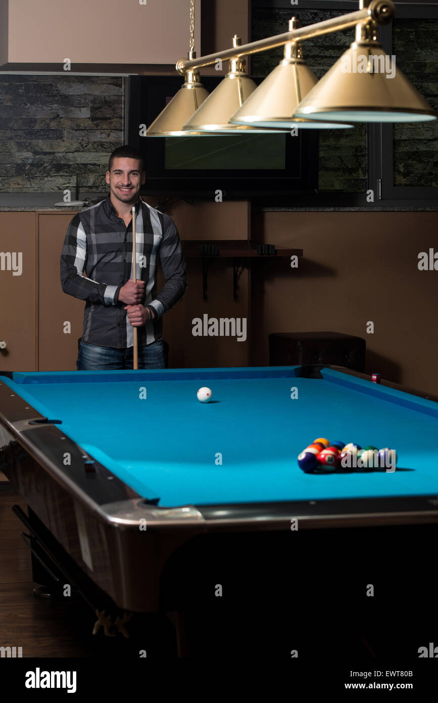 Portrait Of A Young Man Playing Billiards Stock Photo - Alamy