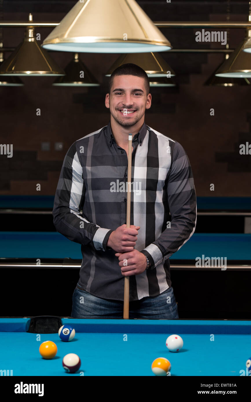Portrait Of A Young Man Playing Billiards Stock Photo - Alamy