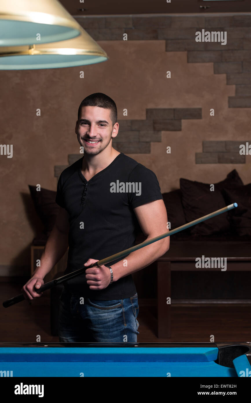 Portrait Of A Young Man Playing Billiards Stock Photo - Alamy