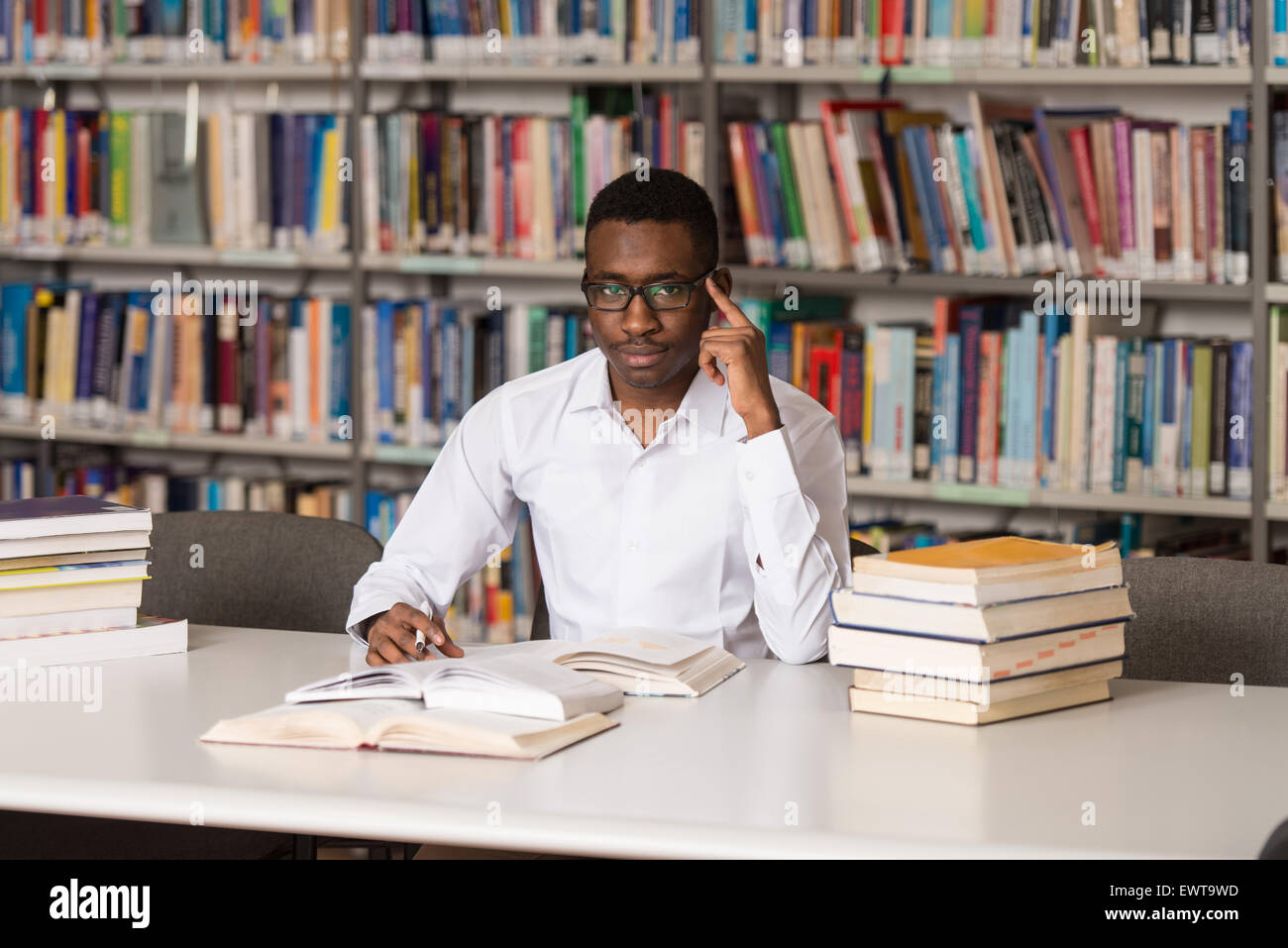 Portrait Of African Clever Student With Open Book Reading It In College ...