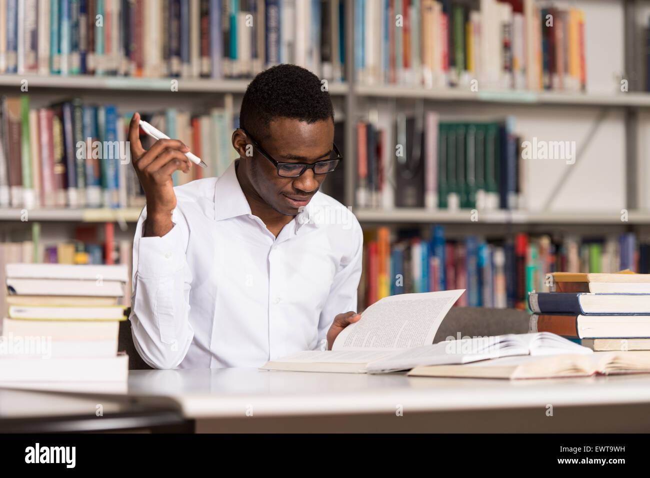 Portrait Of African Clever Student With Open Book Reading It In College ...